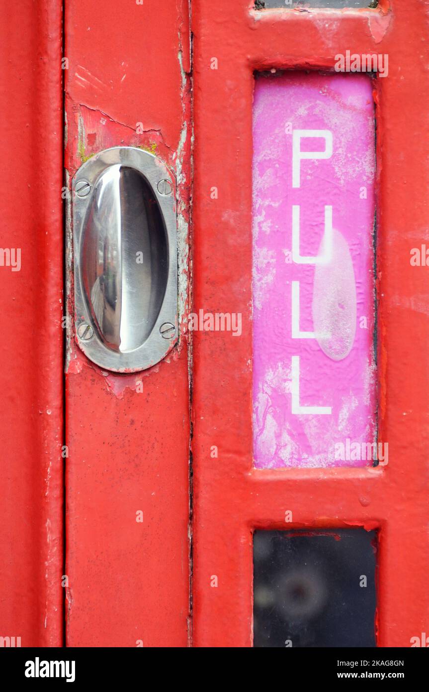 entry handle on old fashioned red telephone box Stock Photo - Alamy