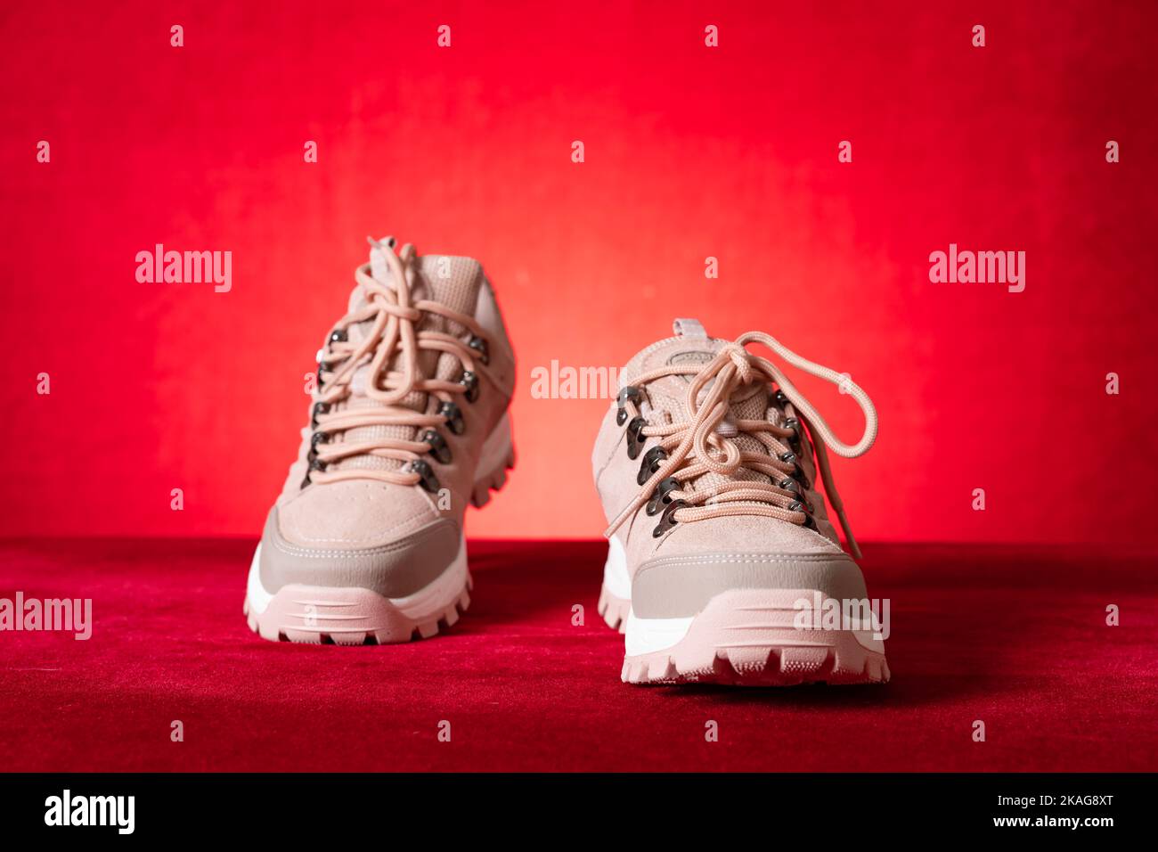 pink color hiking boots for lady on red Stock Photo - Alamy