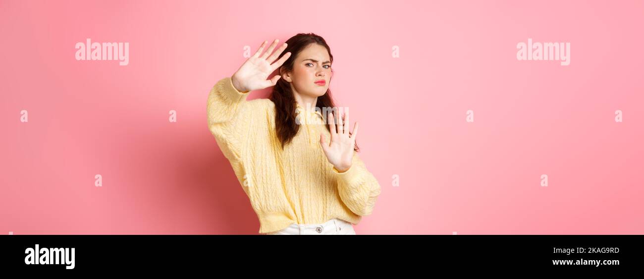 Please stop, enough. Displeased and reluctant young woman stay back ...
