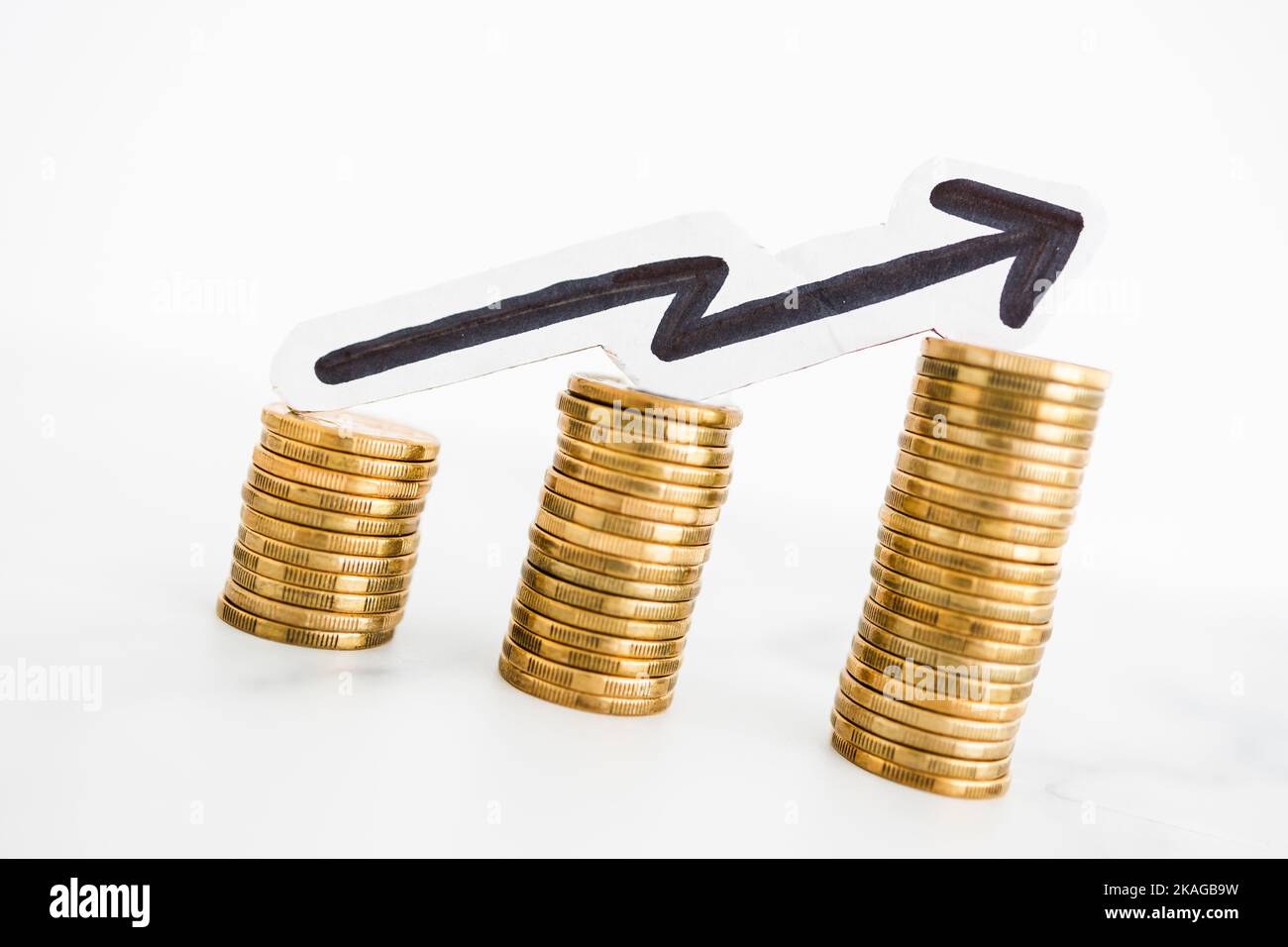 growing stacks of coins with arrow pointing upward, metaphor of ...