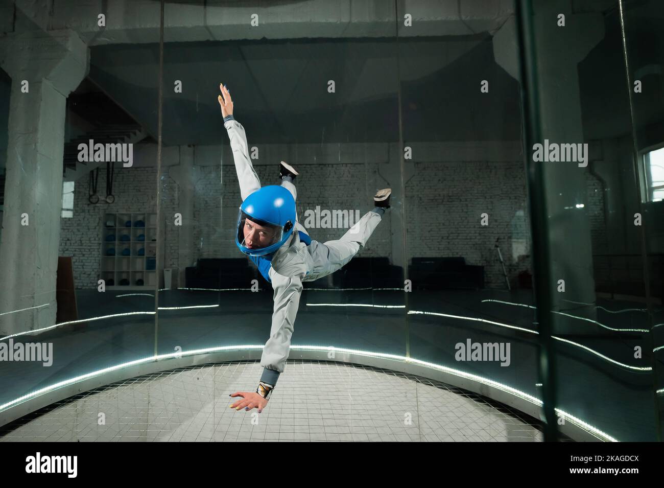 A woman flies in a wind tunnel. Free fall simulator Stock Photo - Alamy