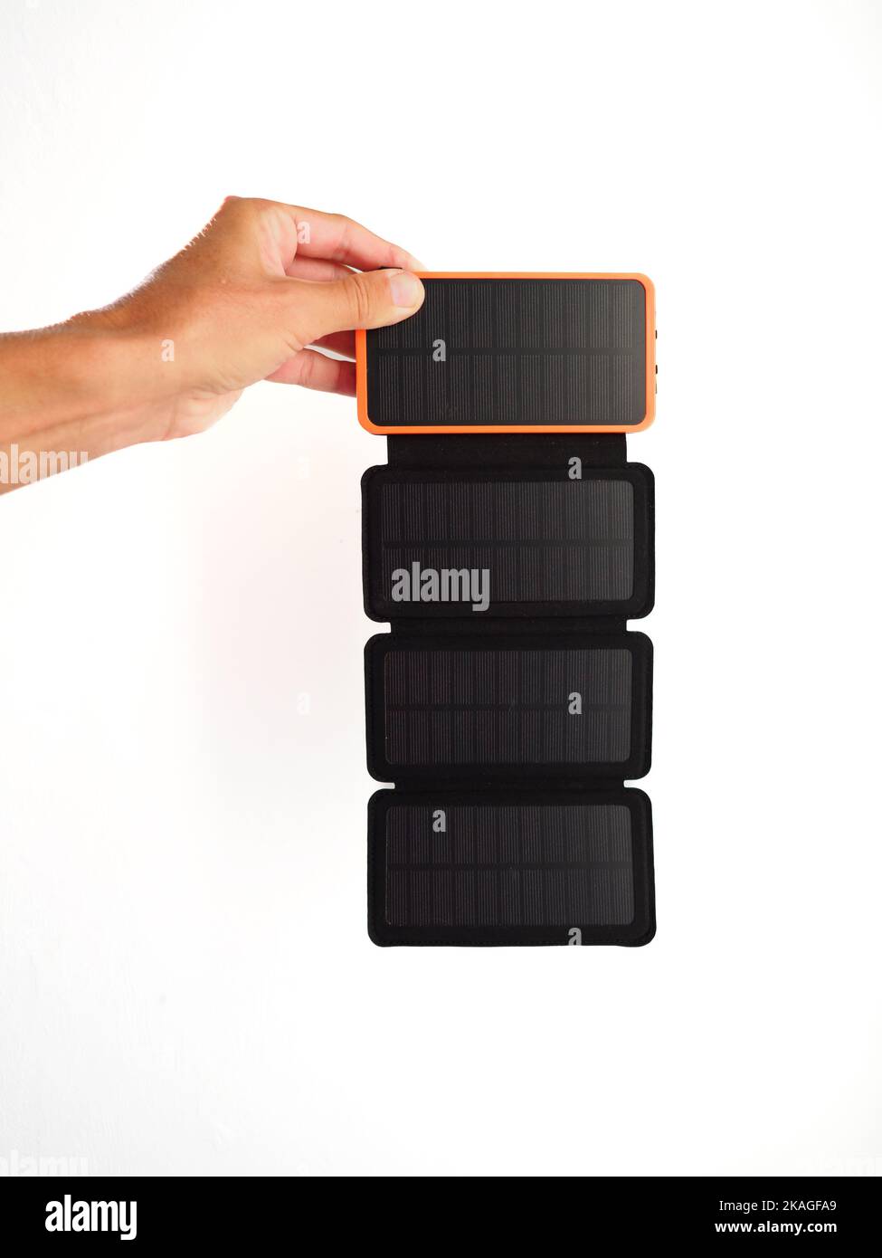 Hand holding small portable solar panel that generates energy Stock ...