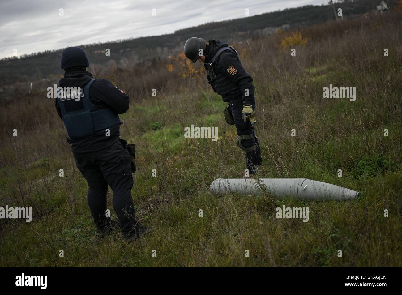 Two Ukrainian explosive ordinance disposal technicians disarm an ...