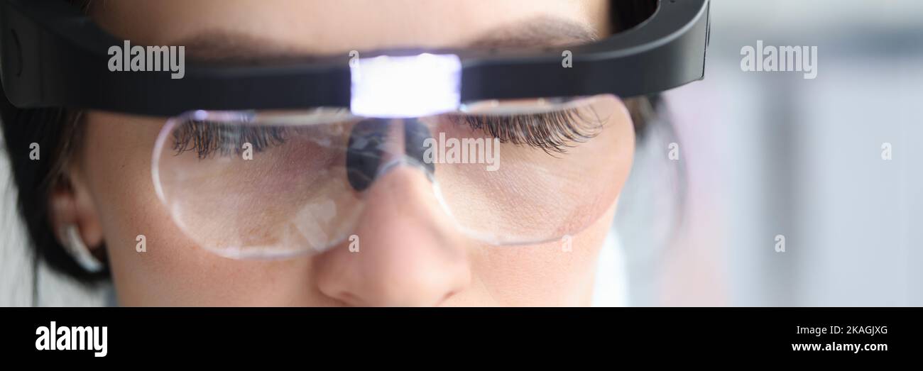 Female examine something wearing magnifying glasses with lighting Stock ...