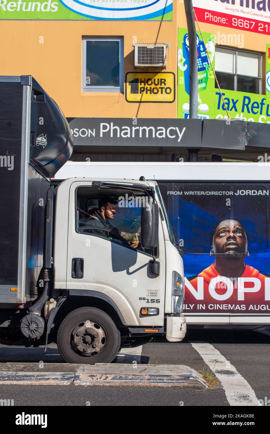 A truck and a bus pass through an intersection on Botany Road, Mascot ...