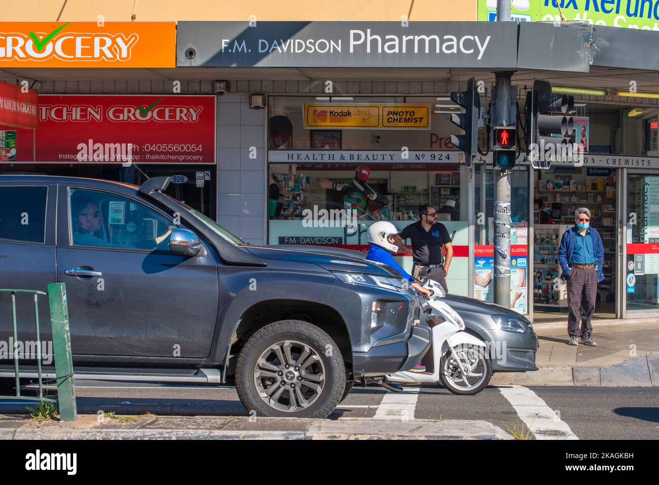 People waiting to cross at an intersection crossing on Botany Road in ...