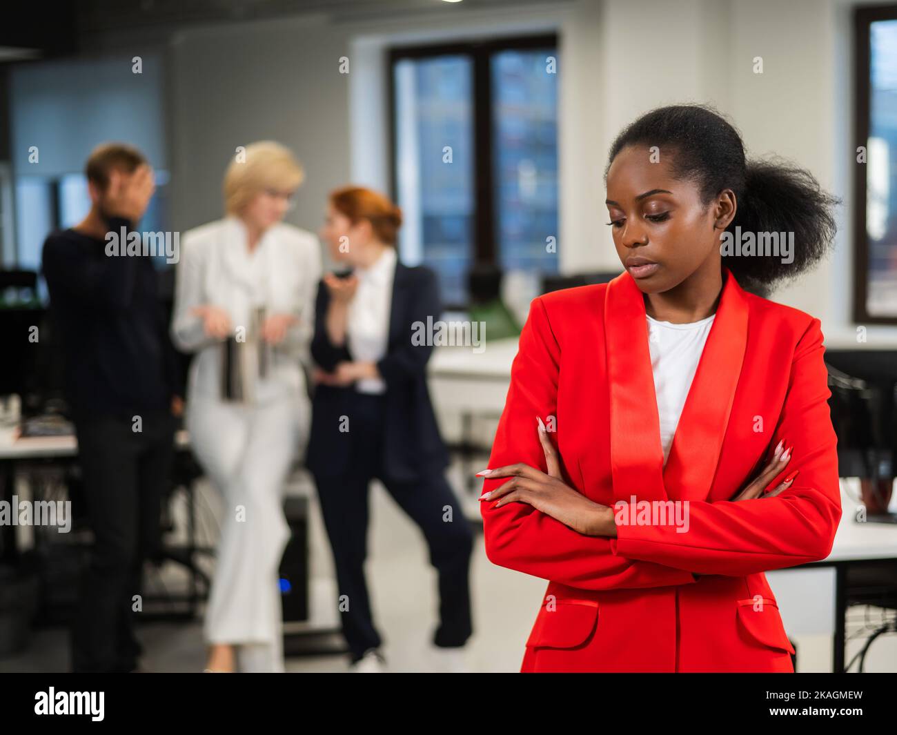 Young african woman is upset because of the ridicule of colleagues ...