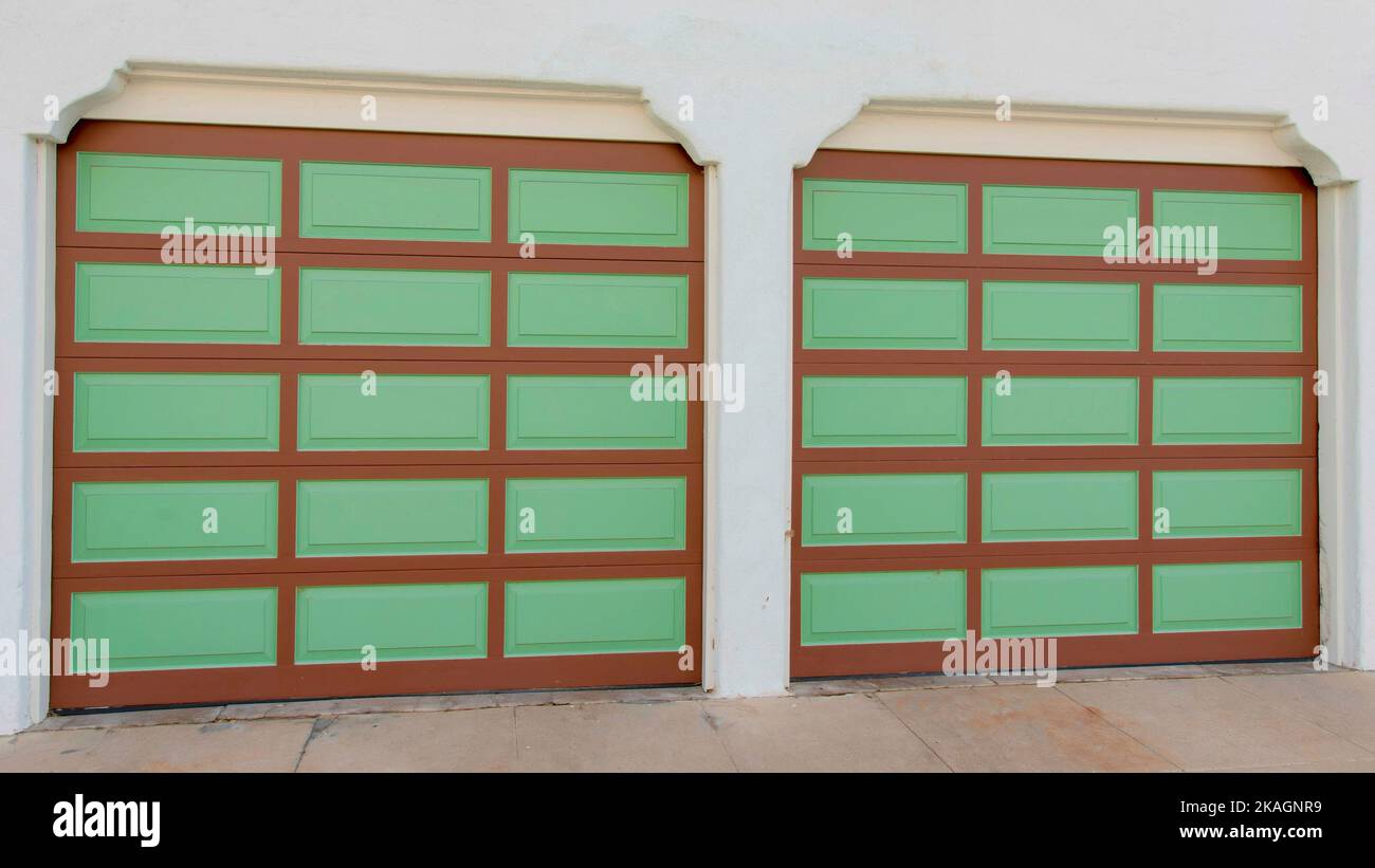 Panorama Two garage doors with brown grid lines and green panels at La ...