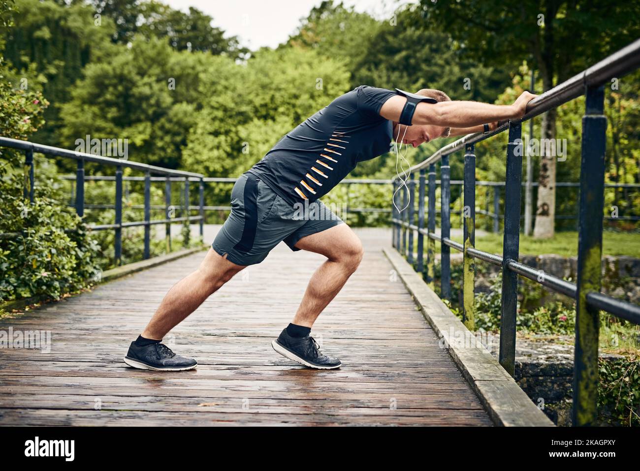 Getting ready for some action. a sporty young man stretching before a ...