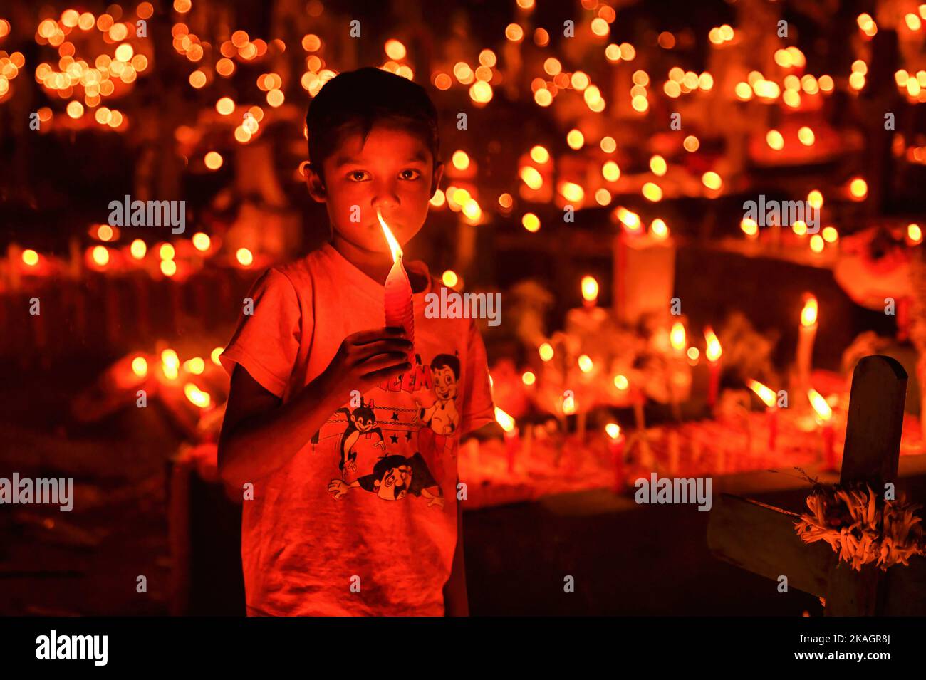 Nadia, India. 02nd Nov, 2022. A kid holds a lit candle in front of the ...