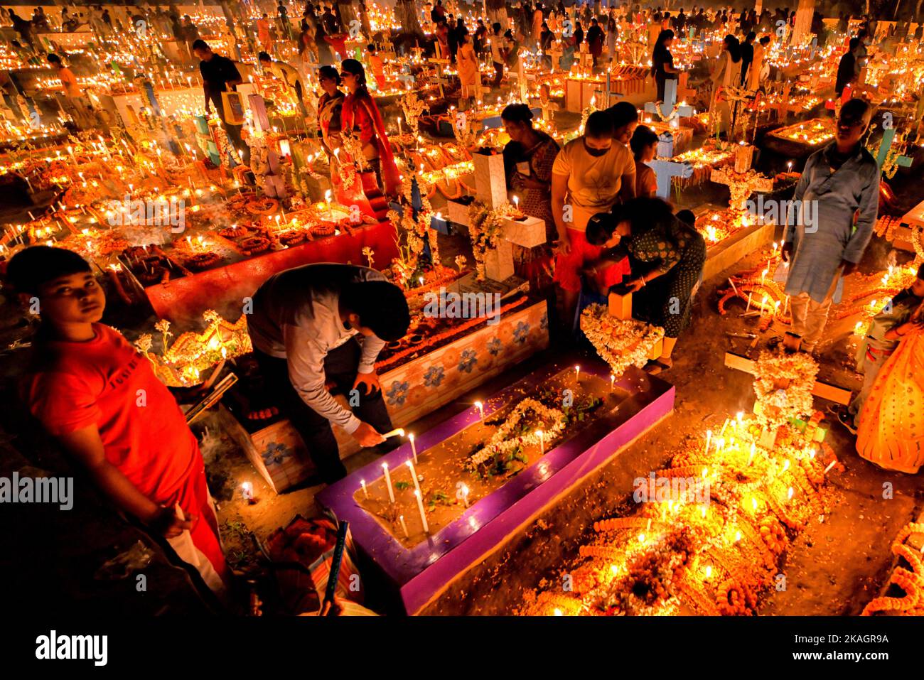Christian family members pay respect and offer prayers beside the grave ...