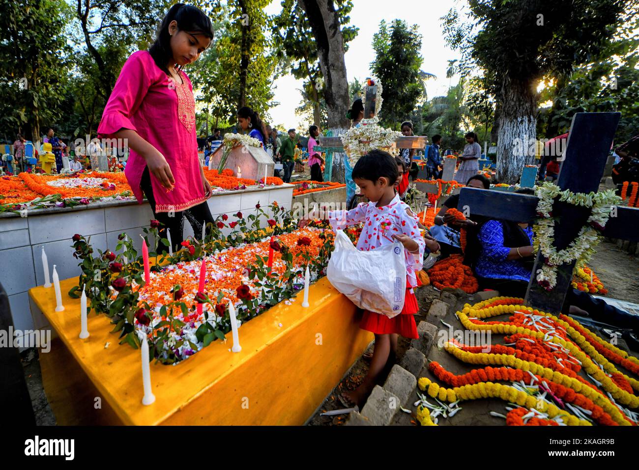 Nadia, India. 02nd Nov, 2022. A kid seen decorating a grave of his ...