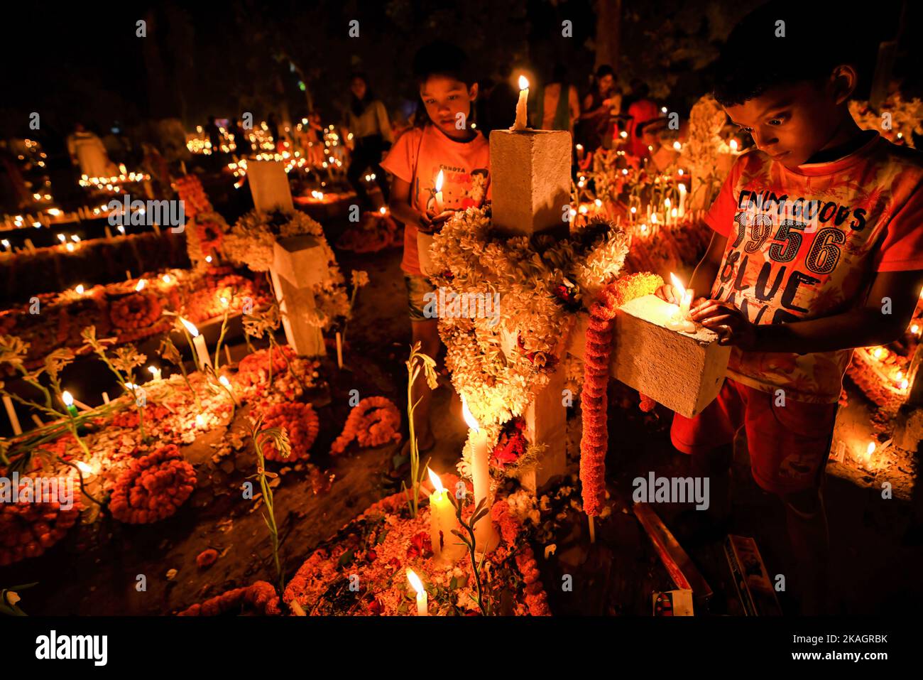 Kids offers prayers beside the grave of their deceased relative during ...