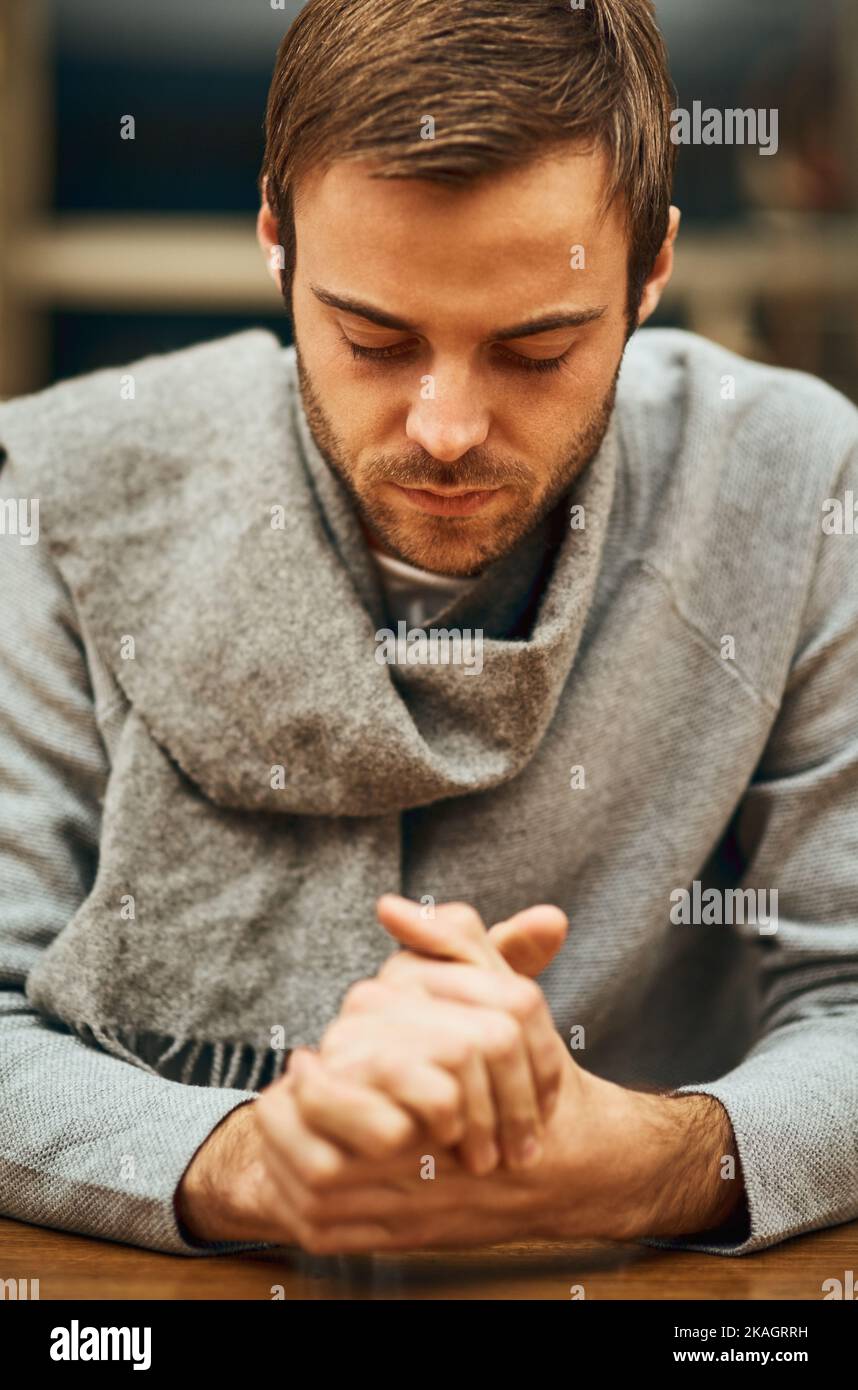 Strength from above. a handsome young man praying for help with his ...