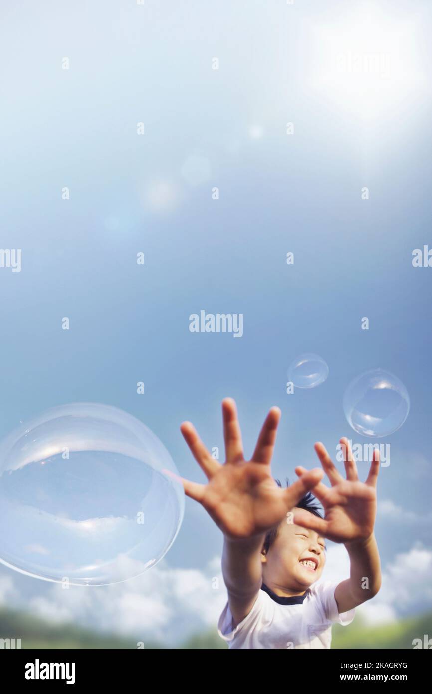 Happy children's day with bright sunlight, clear sky, clouds and soap ...