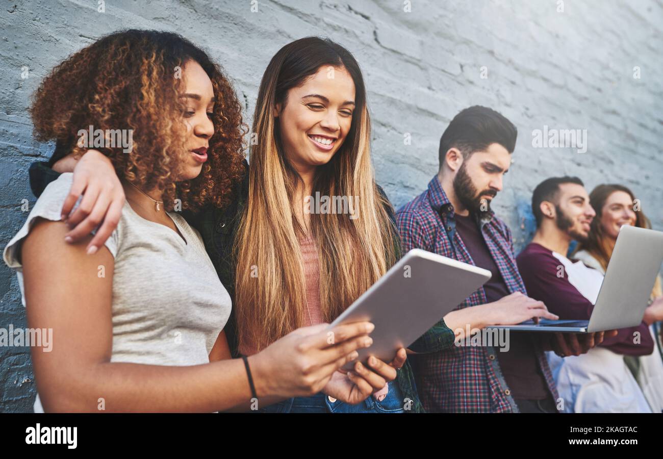 No greater connector than technology. a group of young friends using ...