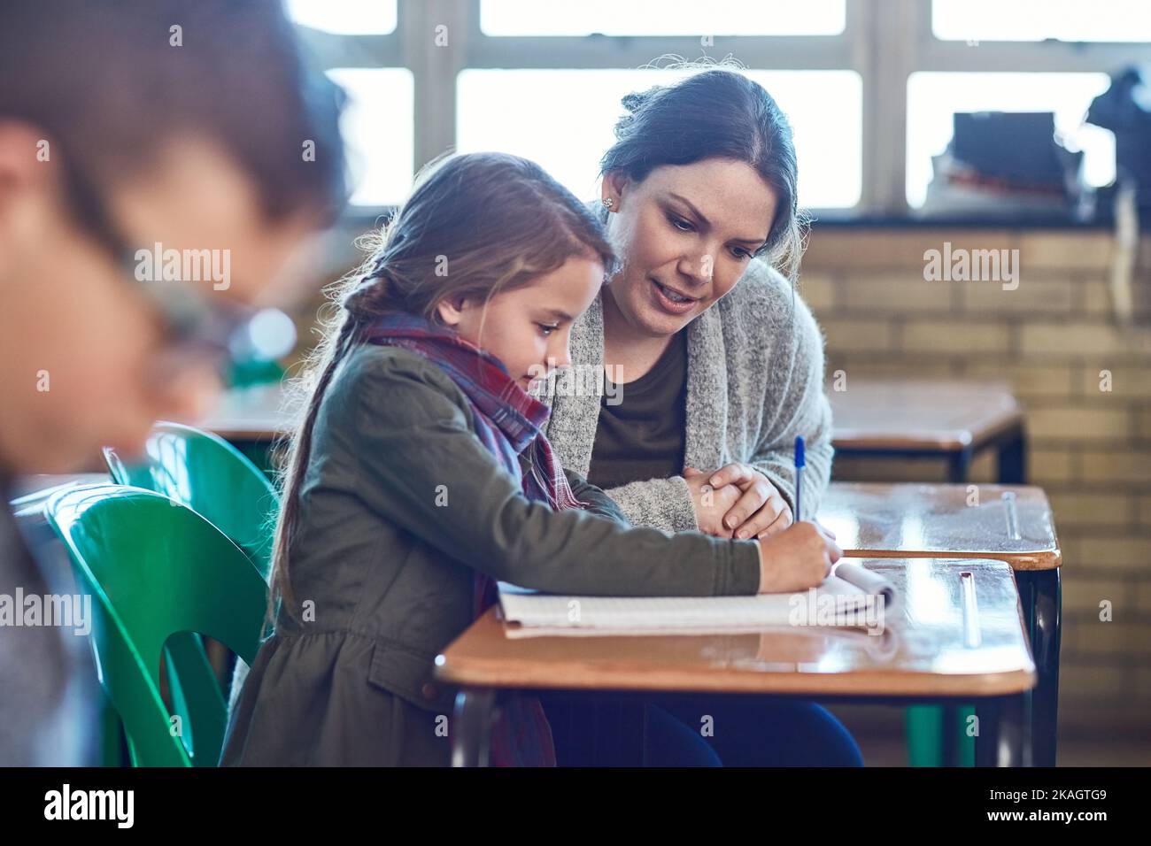 You almost there, you can do this. an elementary school girl getting ...