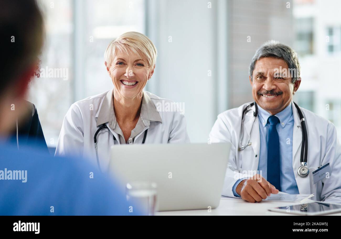 Improving care through collaboration. a team of doctors having a meeting in a hospital Stock ...