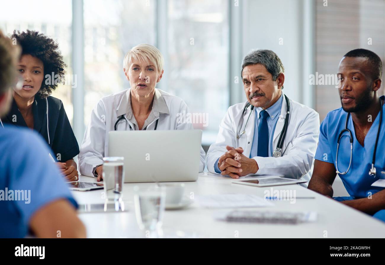Regular meetings keep them in the loop. a team of doctors having a ...