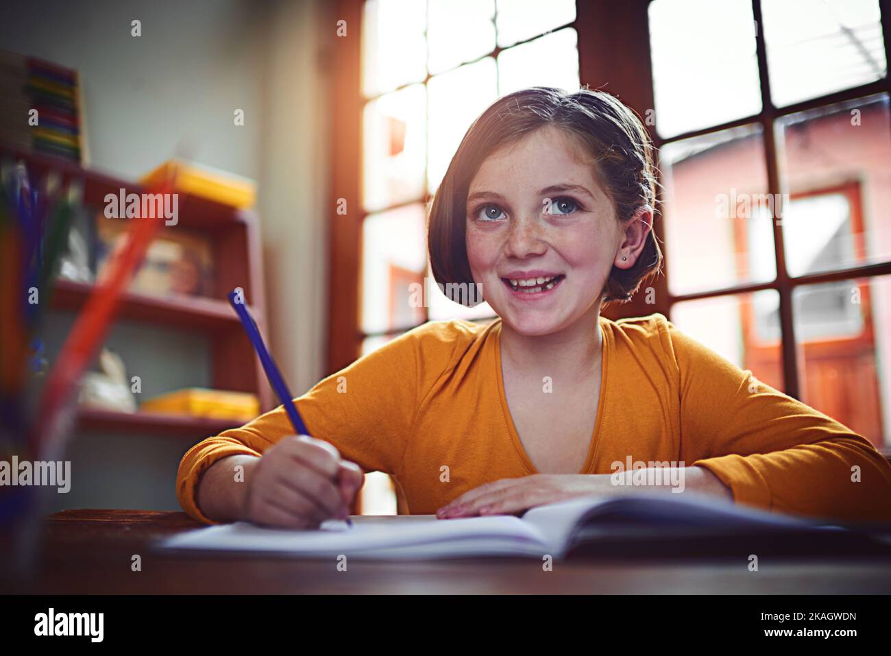 Im the top student in my class. a little girl doing homework inside ...