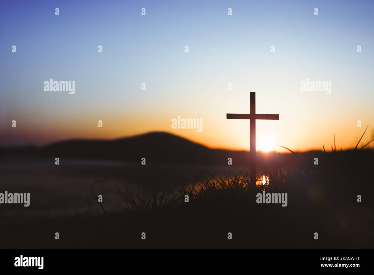 The holy cross of Jesus Christ on the grass with the strong light of ...