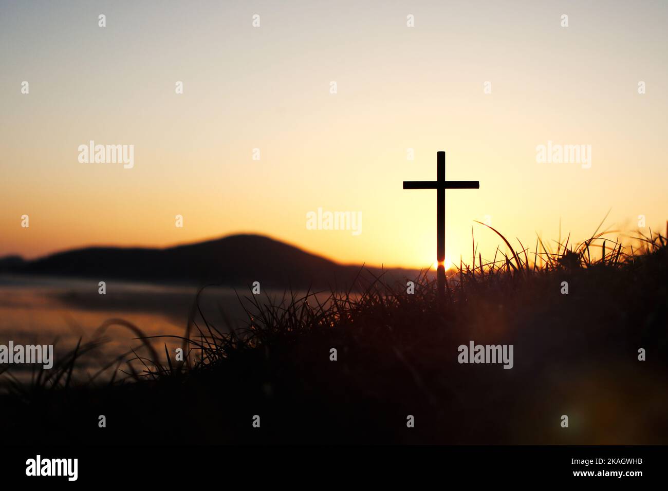 The holy cross of Jesus Christ on the grass with the strong light of ...