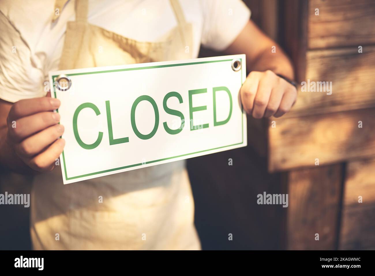 See you next time. an unrecognizable business owner holding up a sign ...
