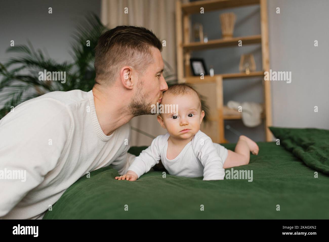 Father and baby at home on the bed together, bedtime Stock Photo - Alamy