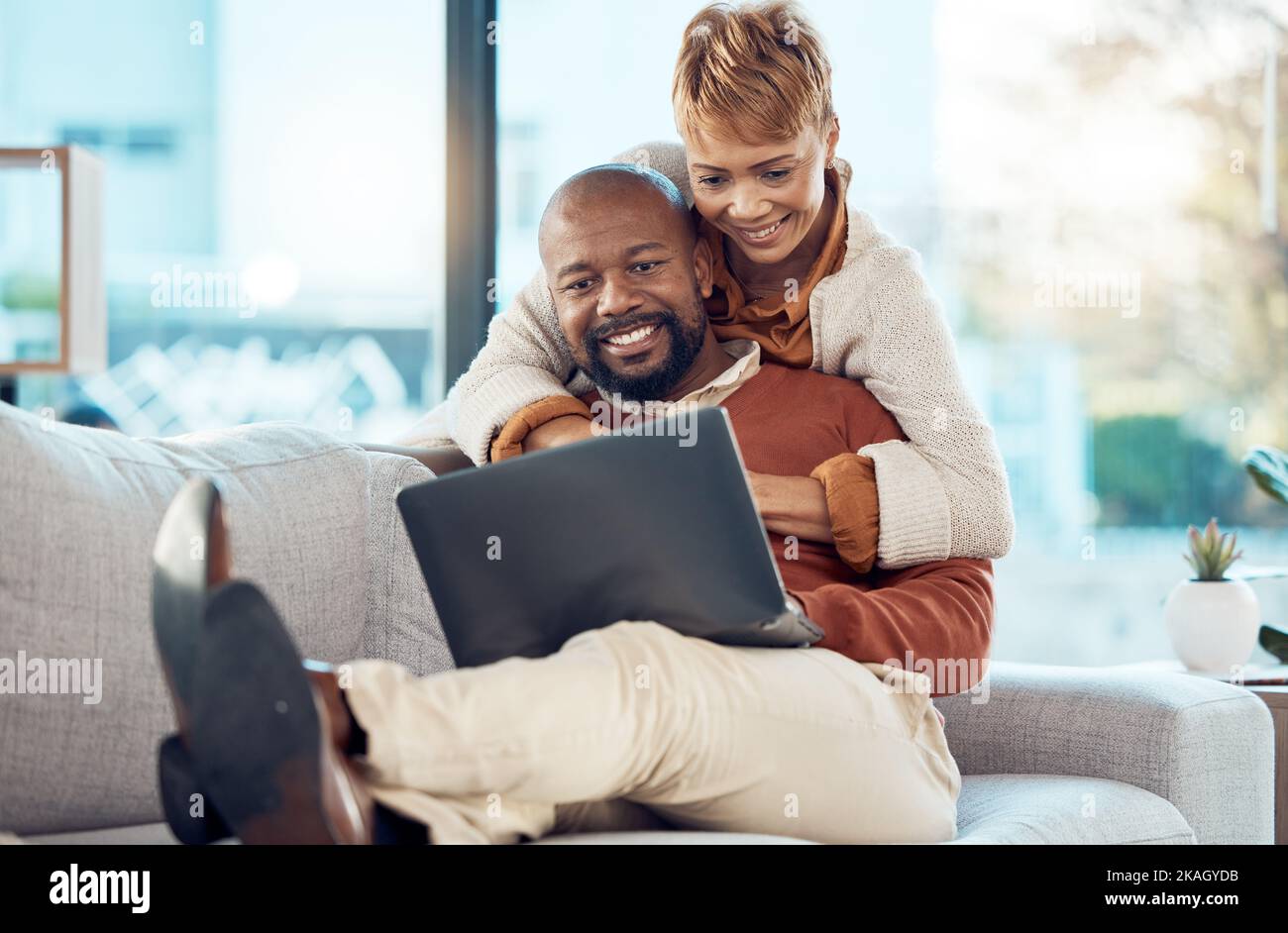 Love, hug and relax black couple on laptop bonding, enjoy quality time ...