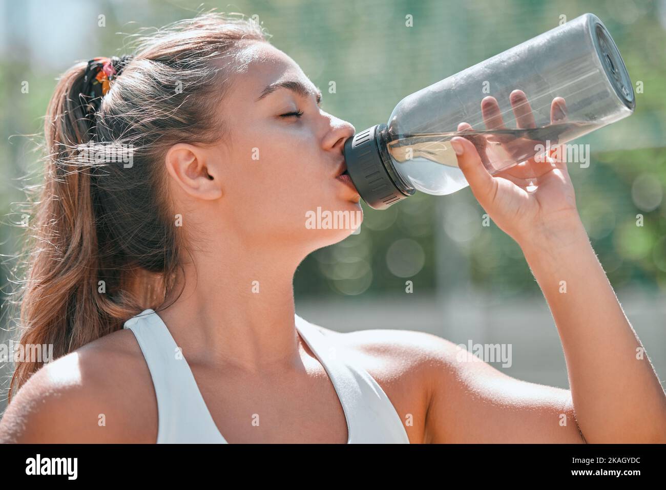 Fitness, woman and drinking water bottle after training workout ...