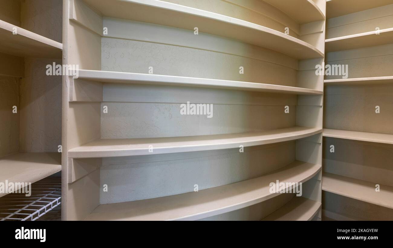 Panorama Kitchen pantry interior of a house with wooden shelving unit ...