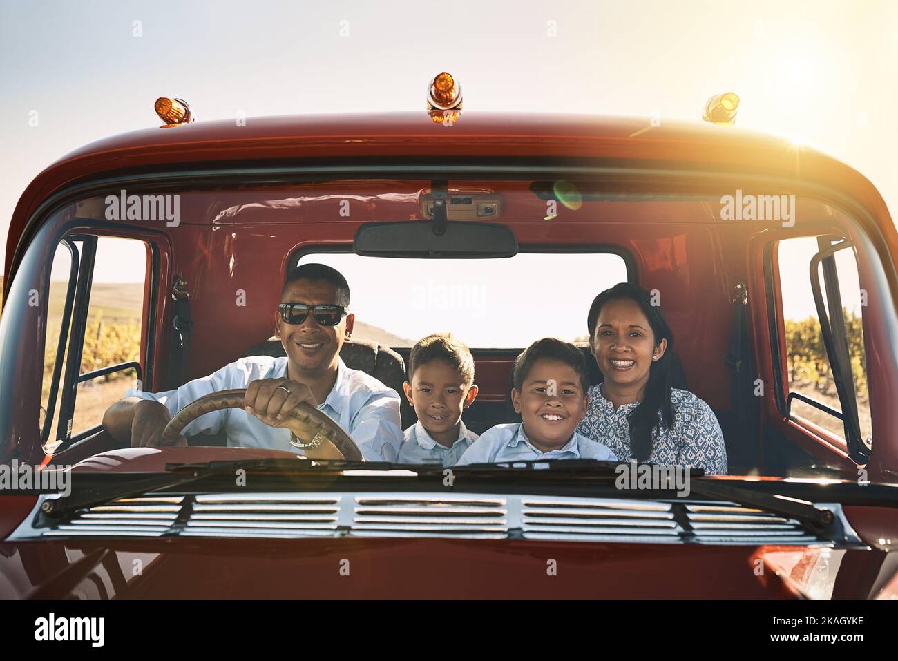 Making the best of the adventure. a cheerful young family driving in a ...