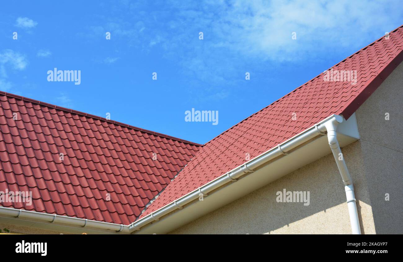 Close up on waterproofing problem area on red steel roof with raing ...