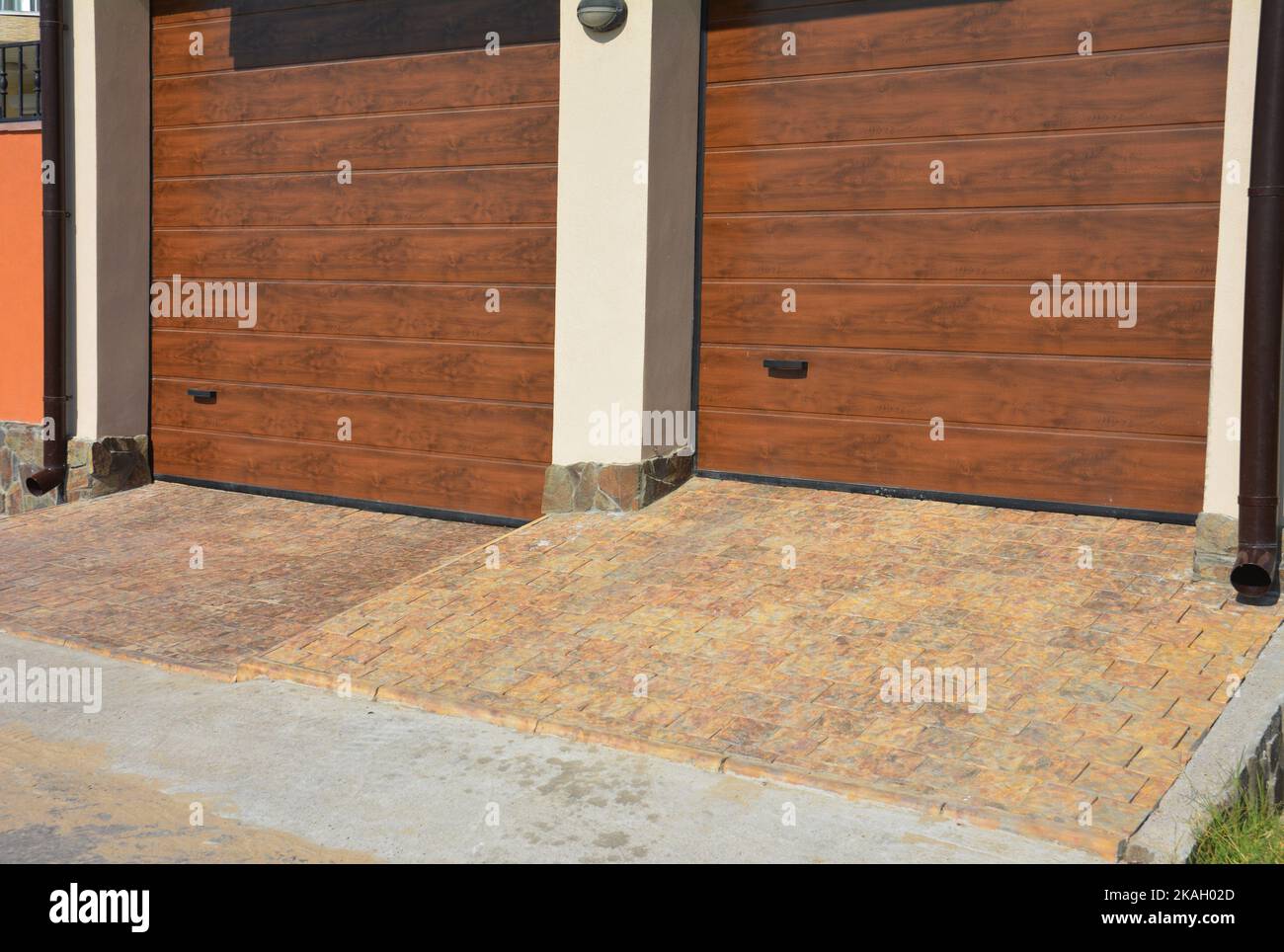 Close up on modern house two garage doors entrace with rain gutter ...