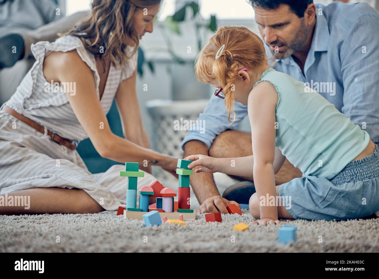 Family, building blocks and girl playing or learning in home, having ...