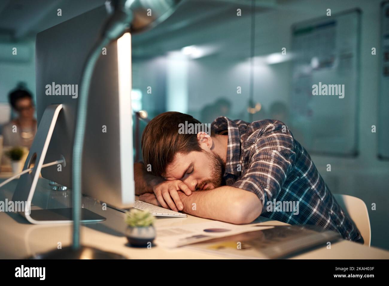 The deadline is tiring him out. a young businessman sleeping on his ...