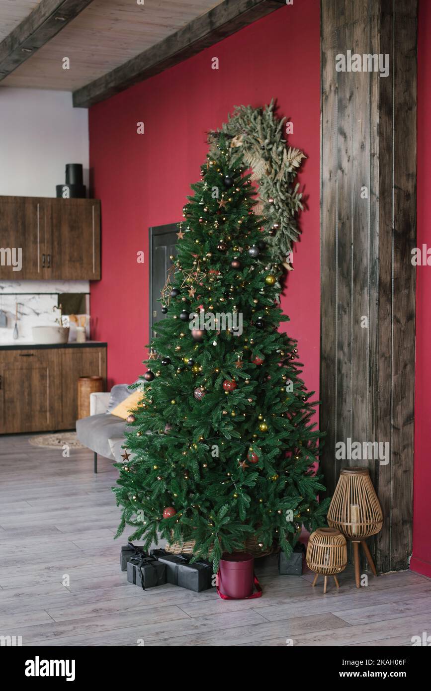 Stylish Christmas tree with gifts under it in a living room with ...