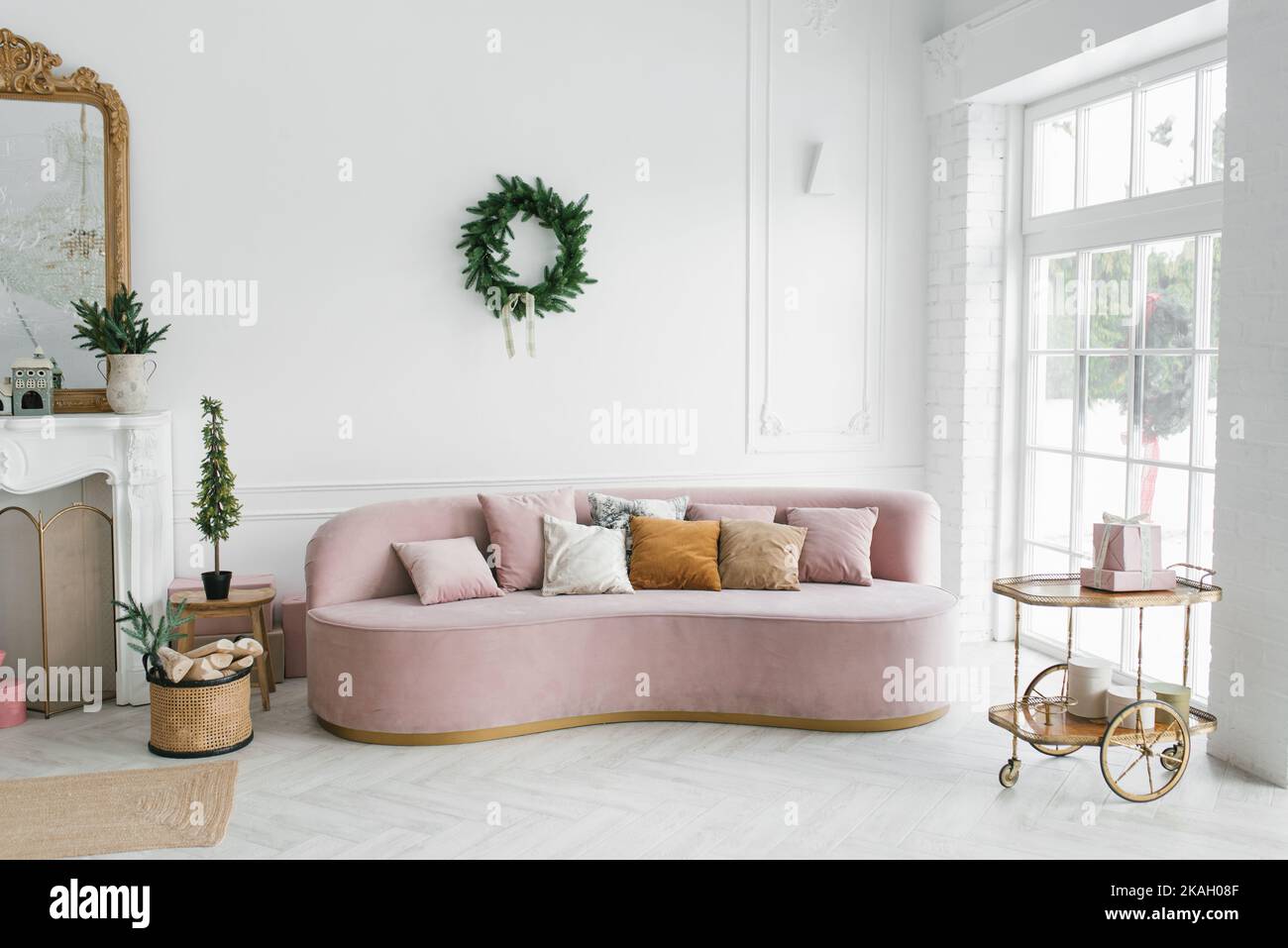 Stylish pink sofa in a classic living room with French windows ...