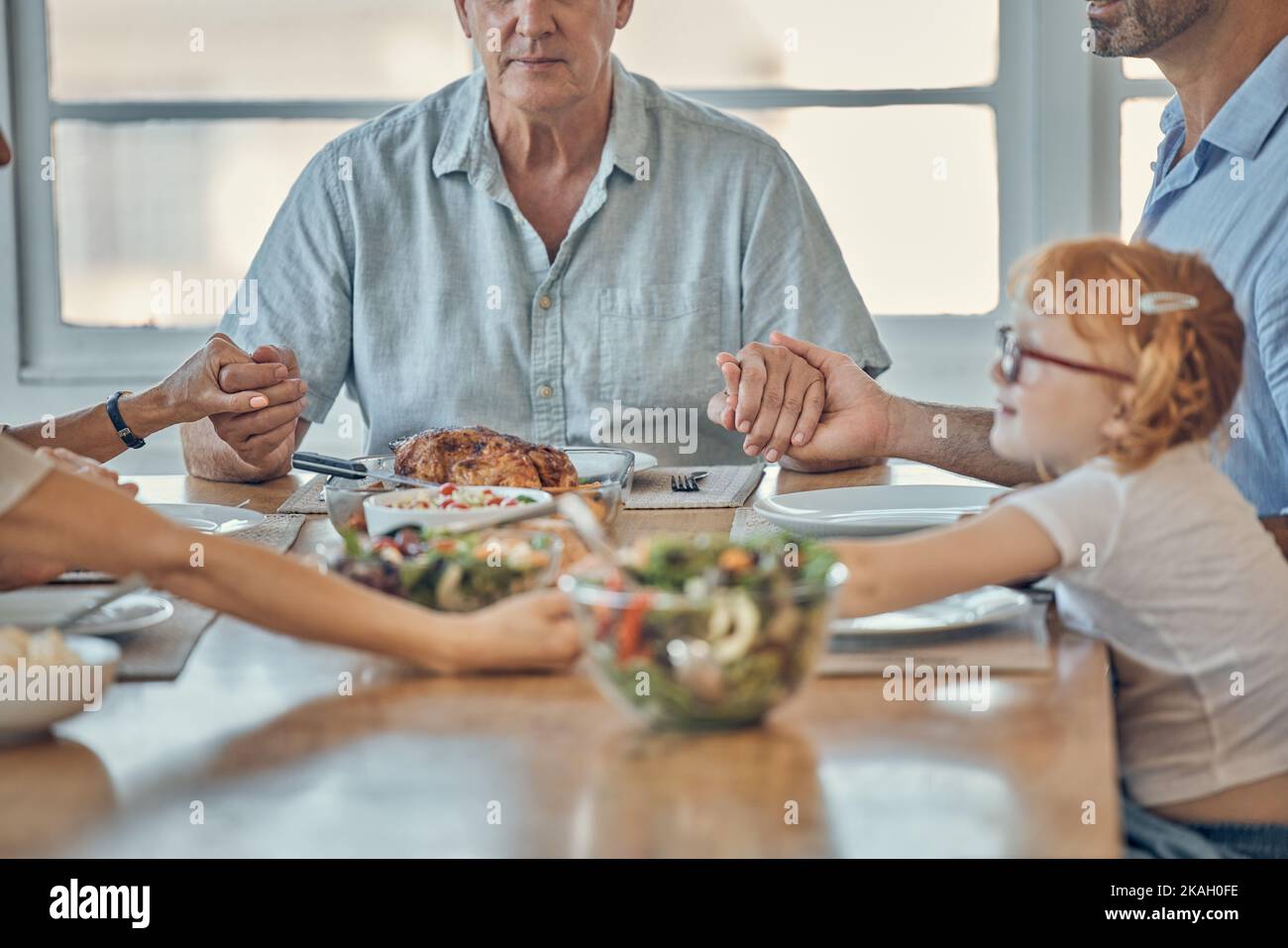 Prayer, food and family holding hands at lunch, brunch or buffet meal ...