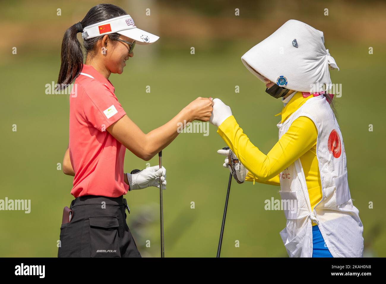 CHONBURI, THAILAND - NOVEMBER 3: Menghan Li of China fist pumps her local caddy on hole 8 during ...