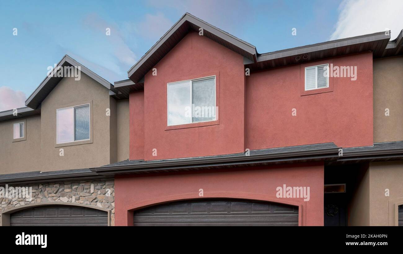 Panorama Puffy clouds at sunset Townhouse exterior with garage and ...