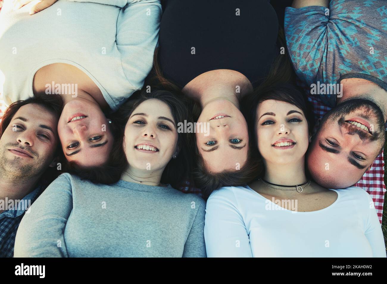 Just hanging out. Portrait of a group of friends lying down with their ...