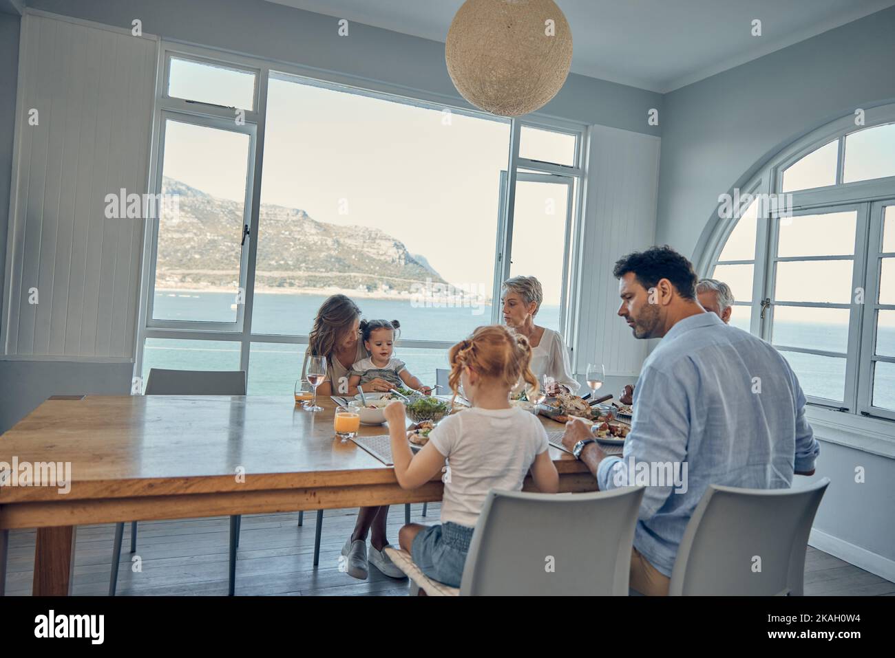 Big family, food and lunch in home dining room with people sharing a ...