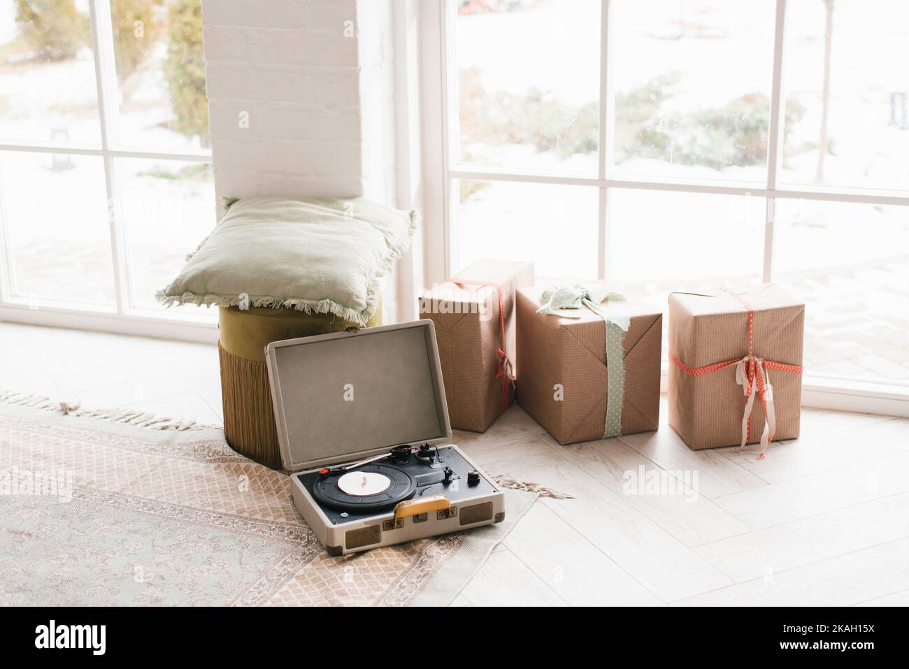 Vintage vinyl record player and gift boxes by the window in the house ...