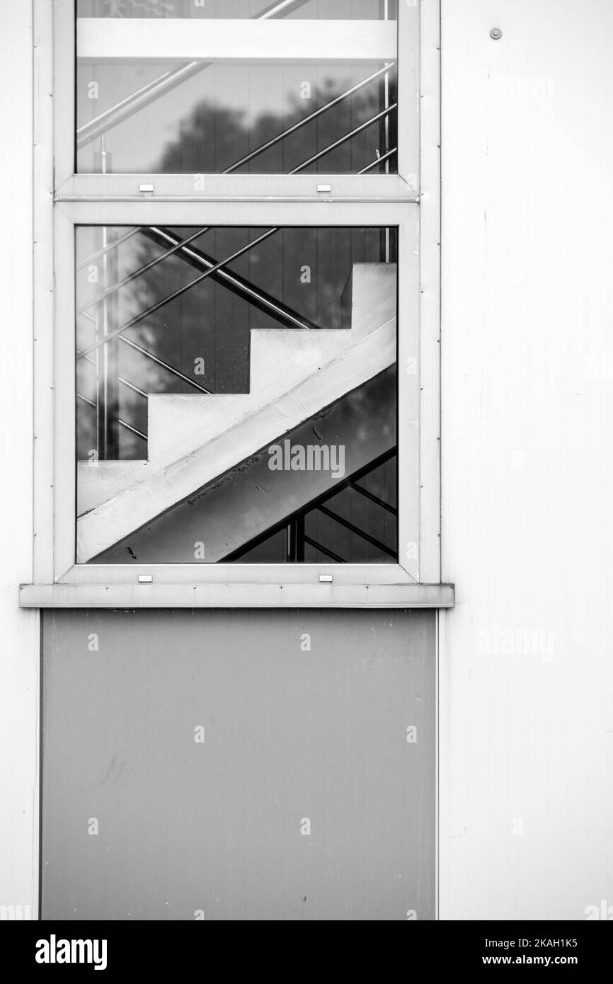 Concrete stairway located behind window of house wall in daytime Stock ...