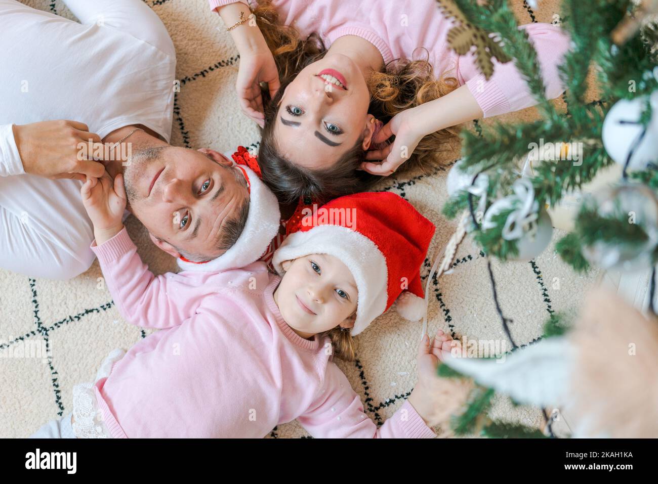 Christmas. Family and Happiness. Top view of dad, mom and daughter ...