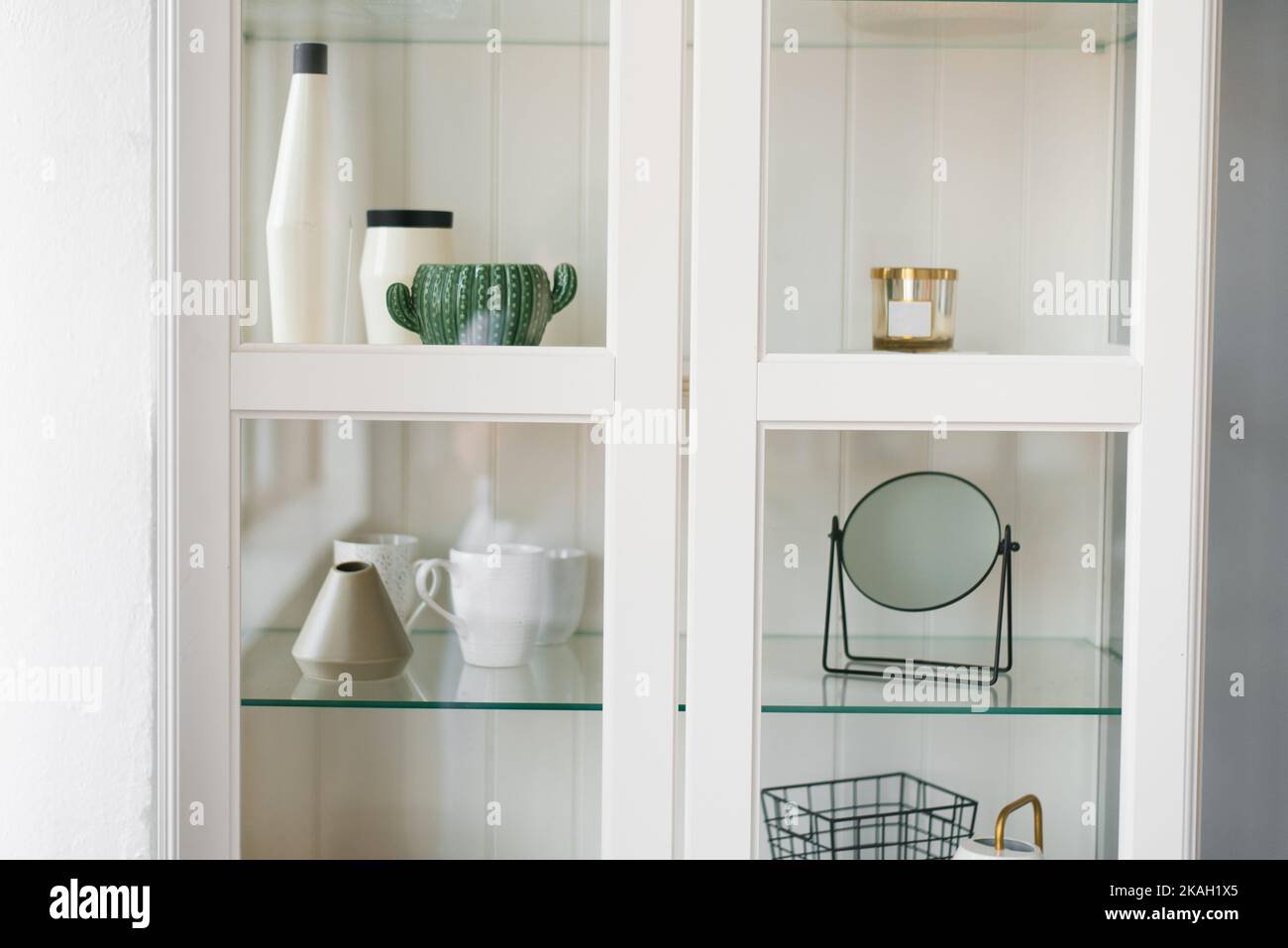 Decorative items on the shelves in the closet behind the glass in the ...