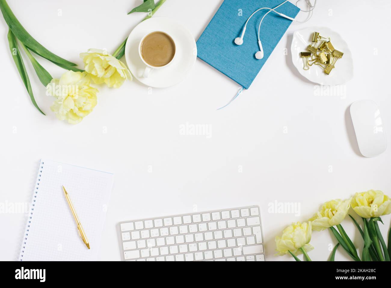 Creative flat layout of the desktop, stationery, keyboard, headphones ...
