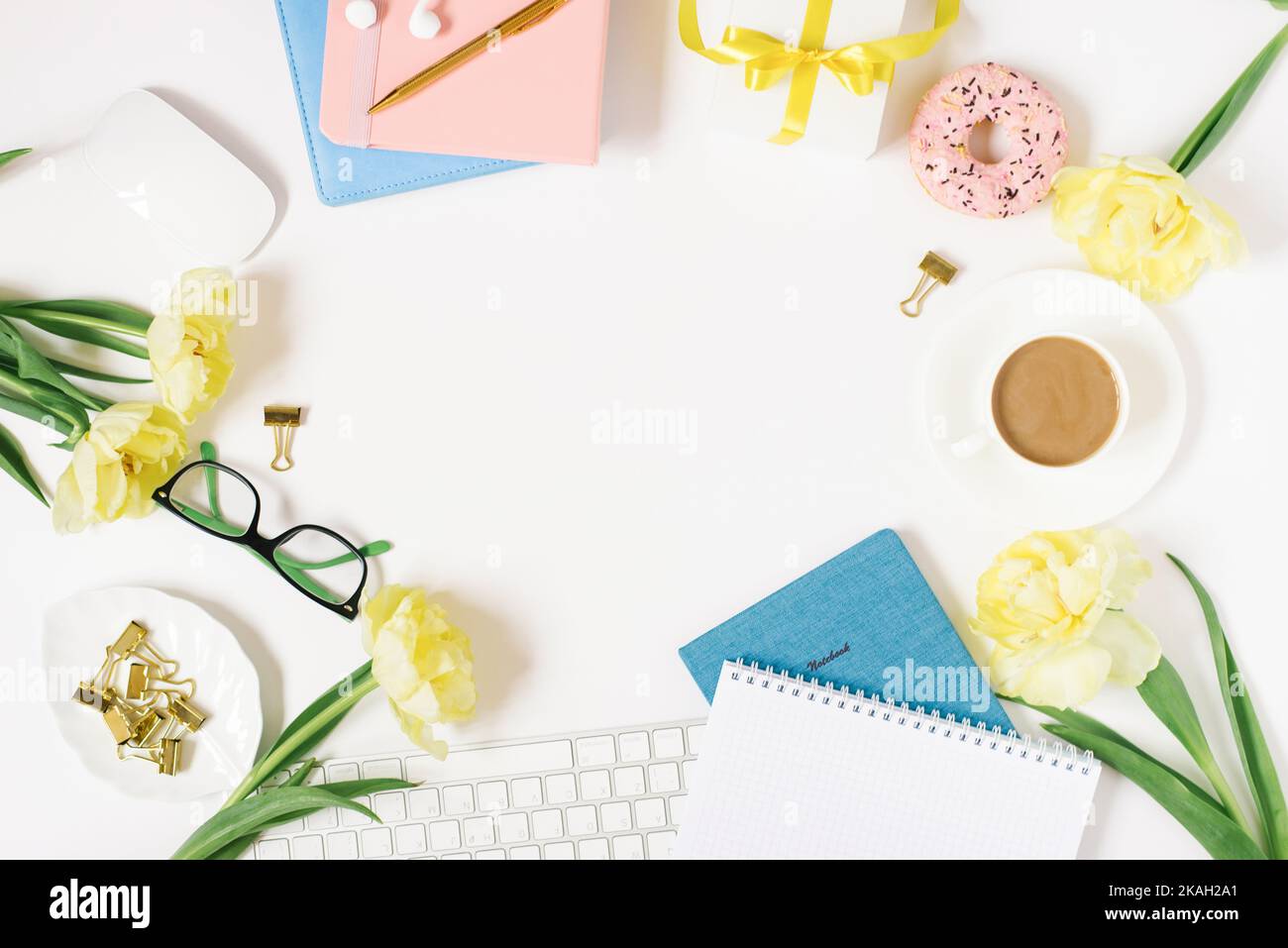 Creative flat layout of desktop, stationery, keyboard, flowers, gift ...