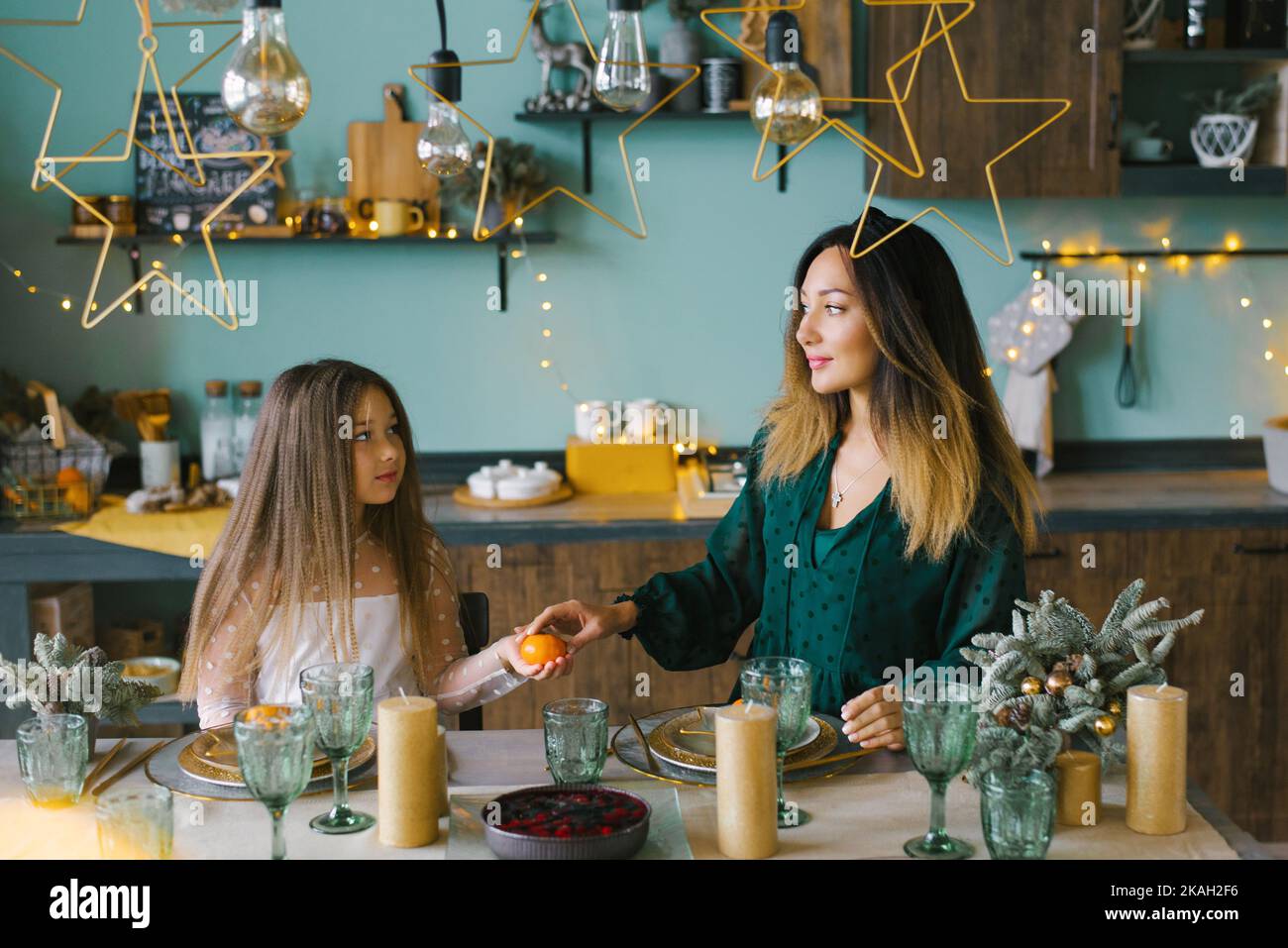 Festive preparation for mom and daughter's Christmas dinner in the ...